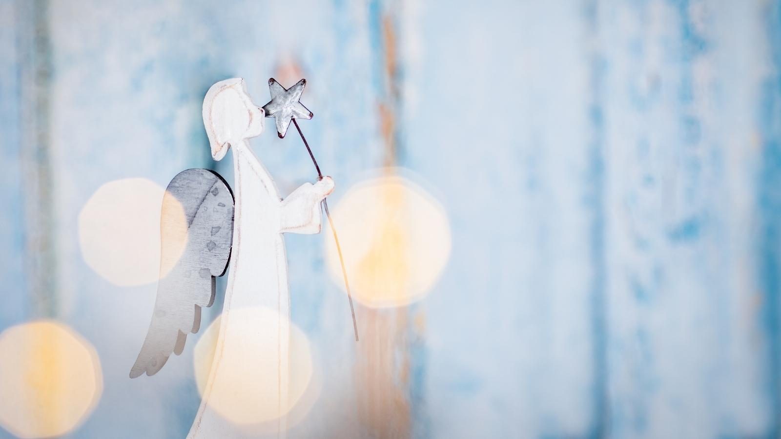 An Angel writing a book